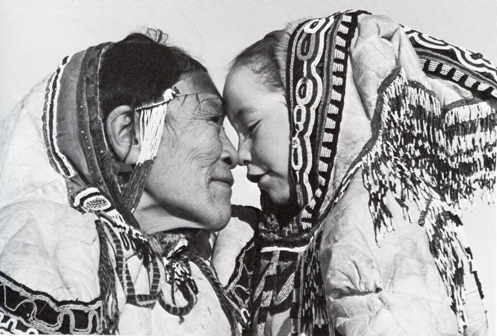 Mom and Daughter giving each other a kunik (Inuit Kiss) Padlei, Nunavut ...
