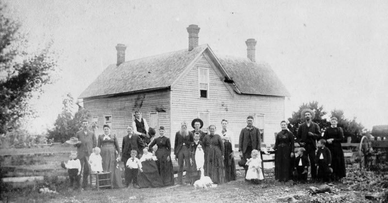 Three generations of an extended family, gathered in family groups ...