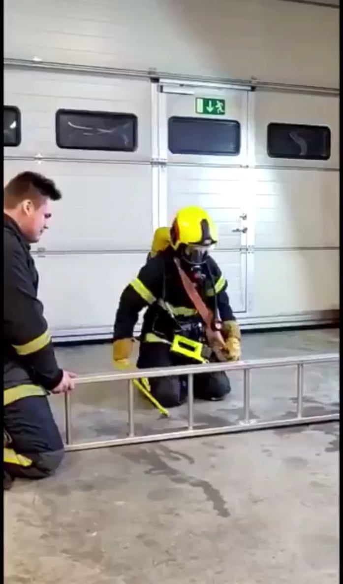 Firefighter fitting through the rung of a ladder - USLUCK