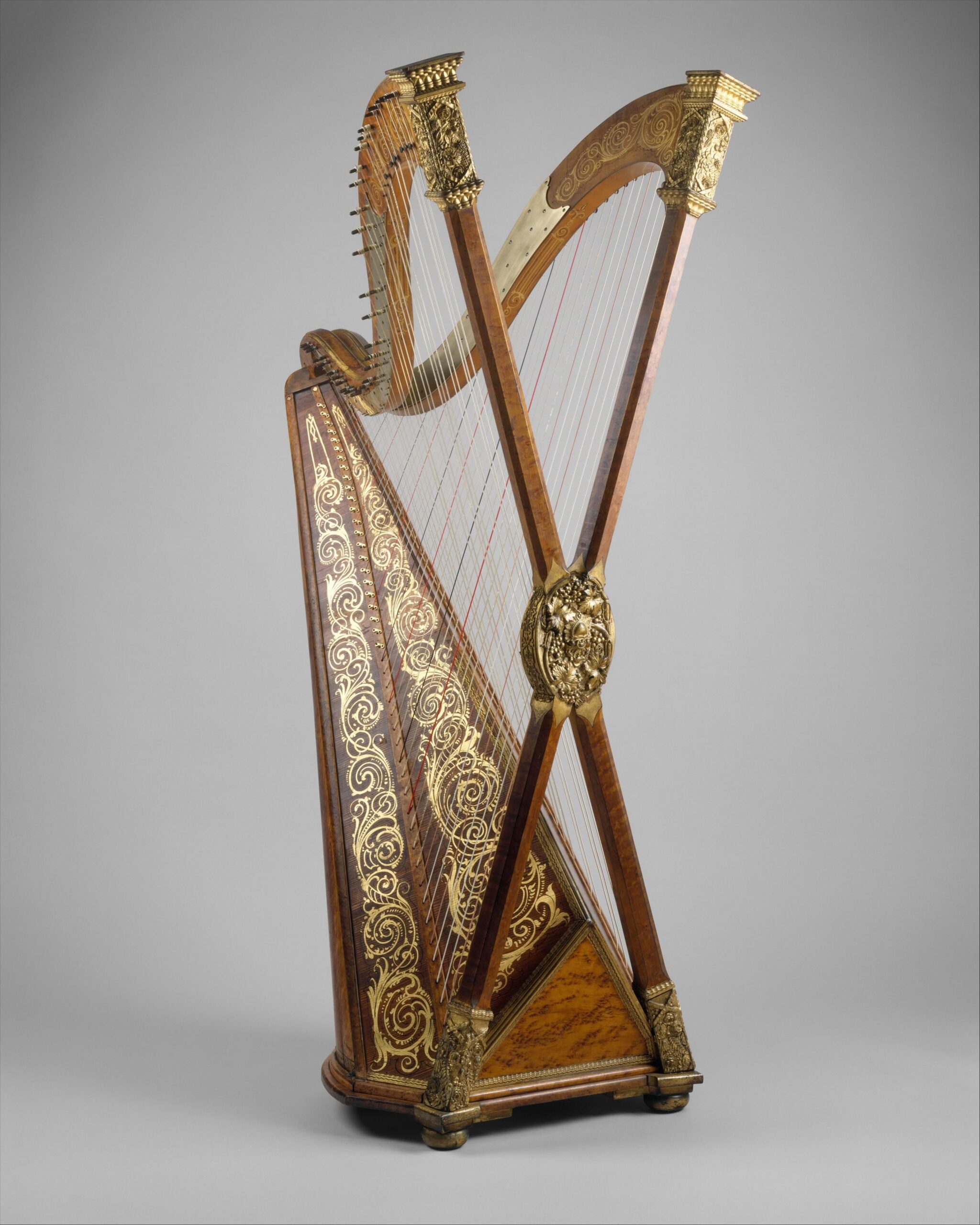 Double chromatic harp with two sets of strings that cross near their ...