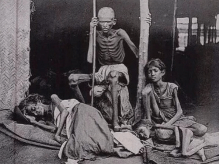 Man stands guard over his starving family, shielding them from the ...
